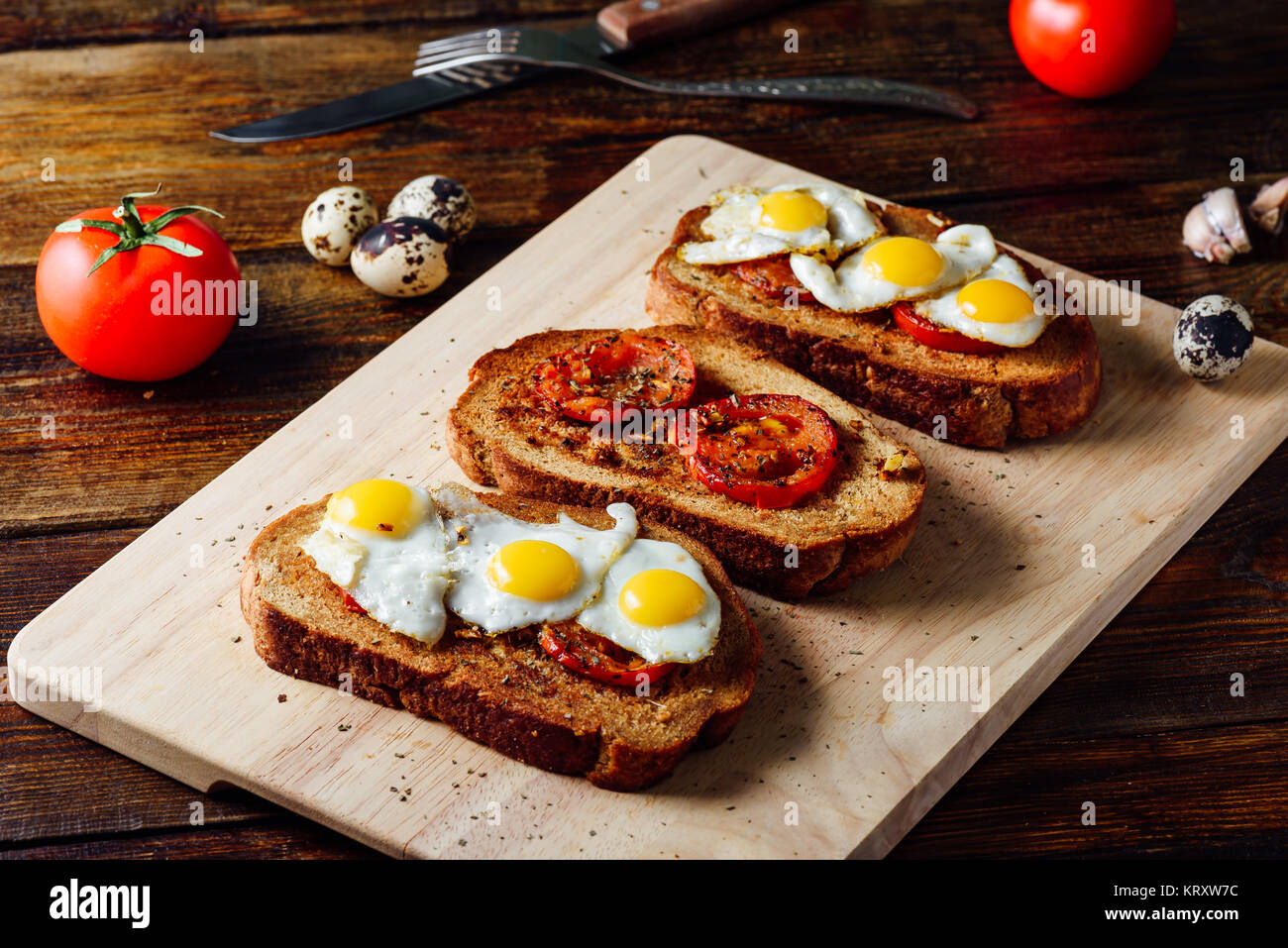 Three Toasts with Eggs and Tomatoes Stock Photo - Alamy