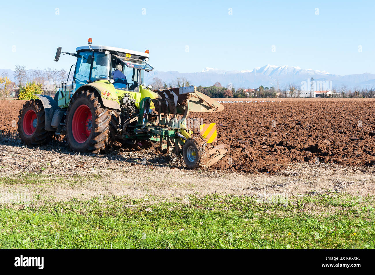 Tractor plowing a field Stock Photo - Alamy