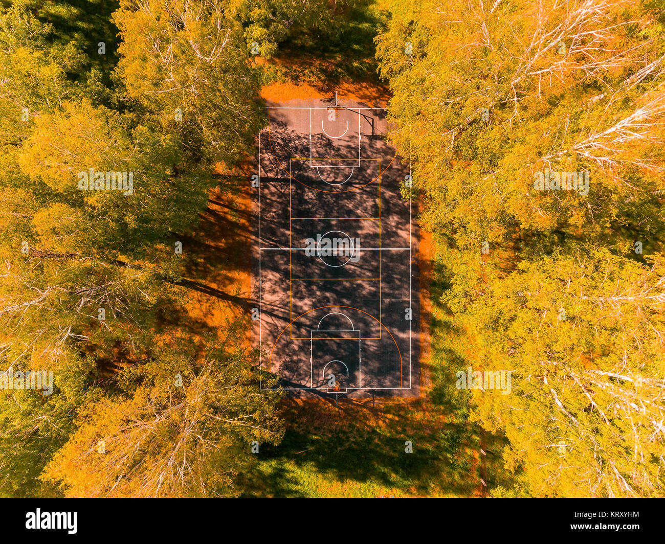 Aerial view of basketball field on day time in forest. Above with drone ...