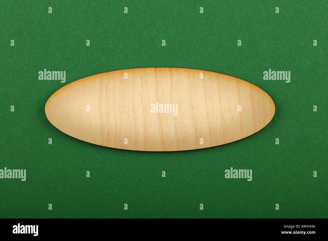 Ellipse shaped wooden sign on green background Stock Photo - Alamy