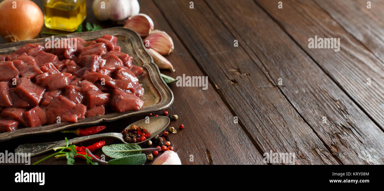 Raw beef liver with spices, herbs and vegetables Stock Photo - Alamy