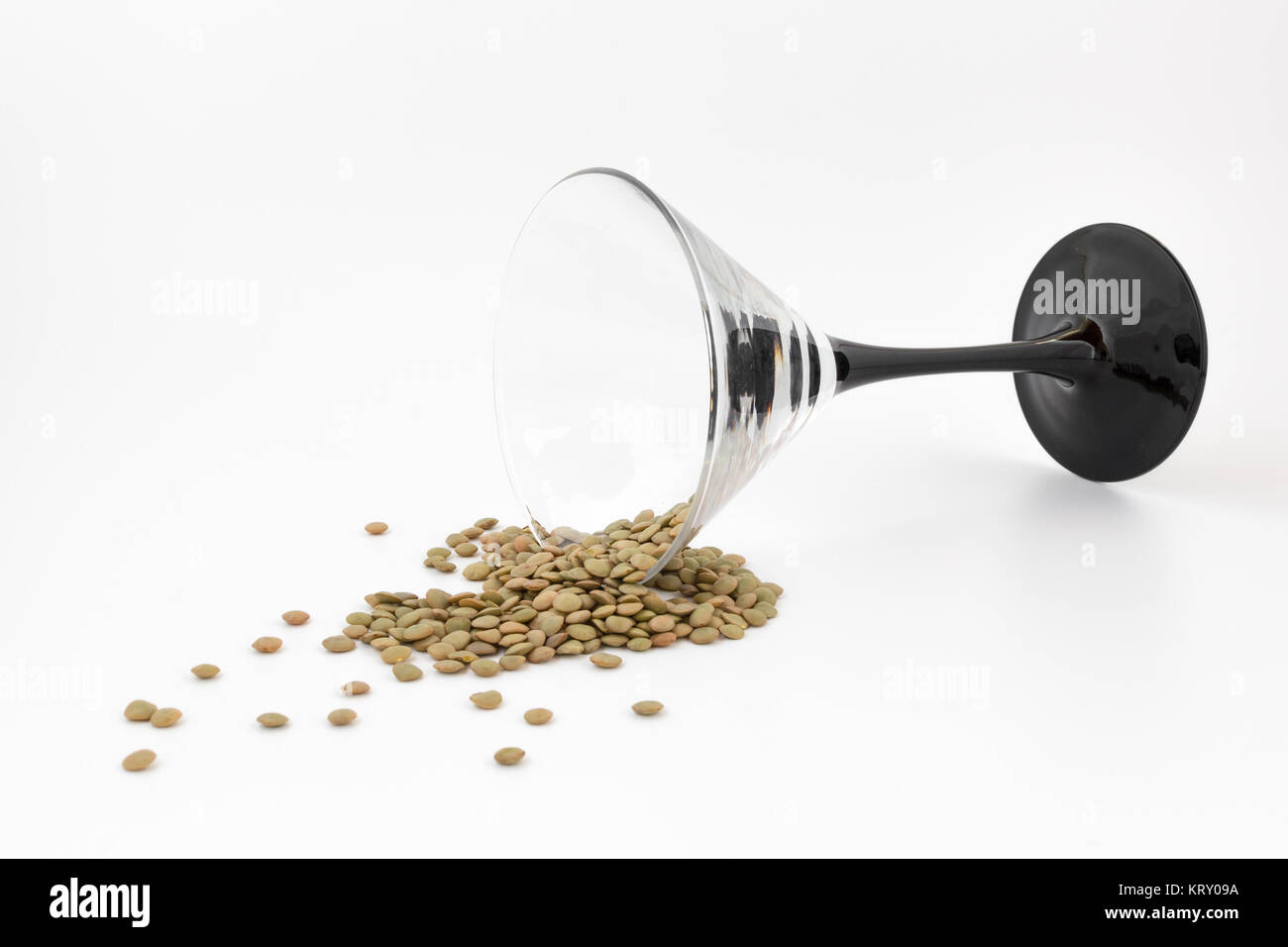 Lentils and overturned glass Stock Photo - Alamy