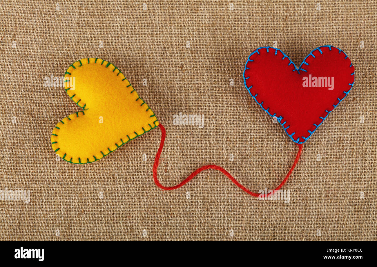 Two felt craft hearts, yellow and red on canvas Stock Photo - Alamy