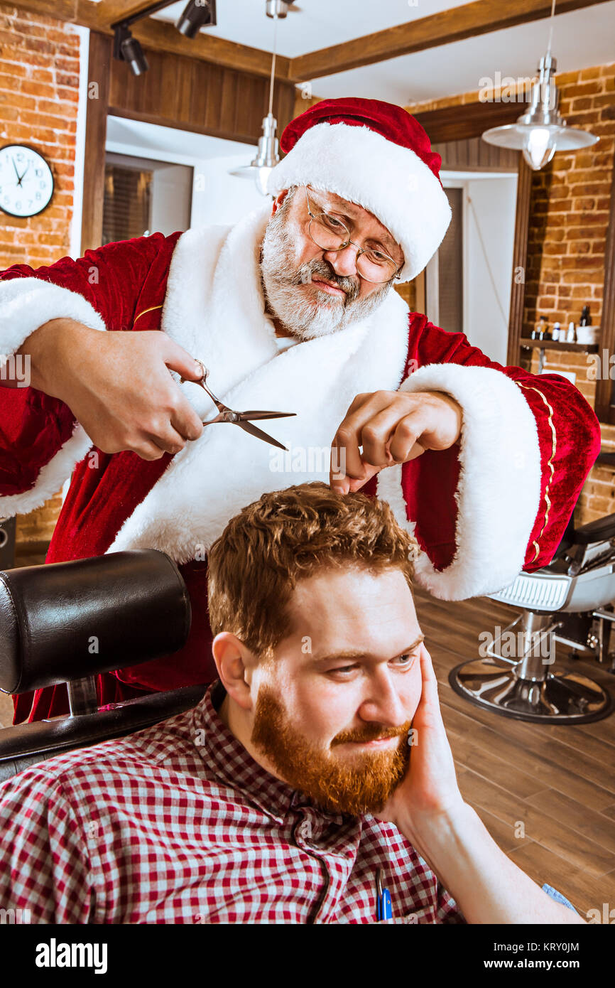 Santa claus as master at barber shop Stock Photo - Alamy