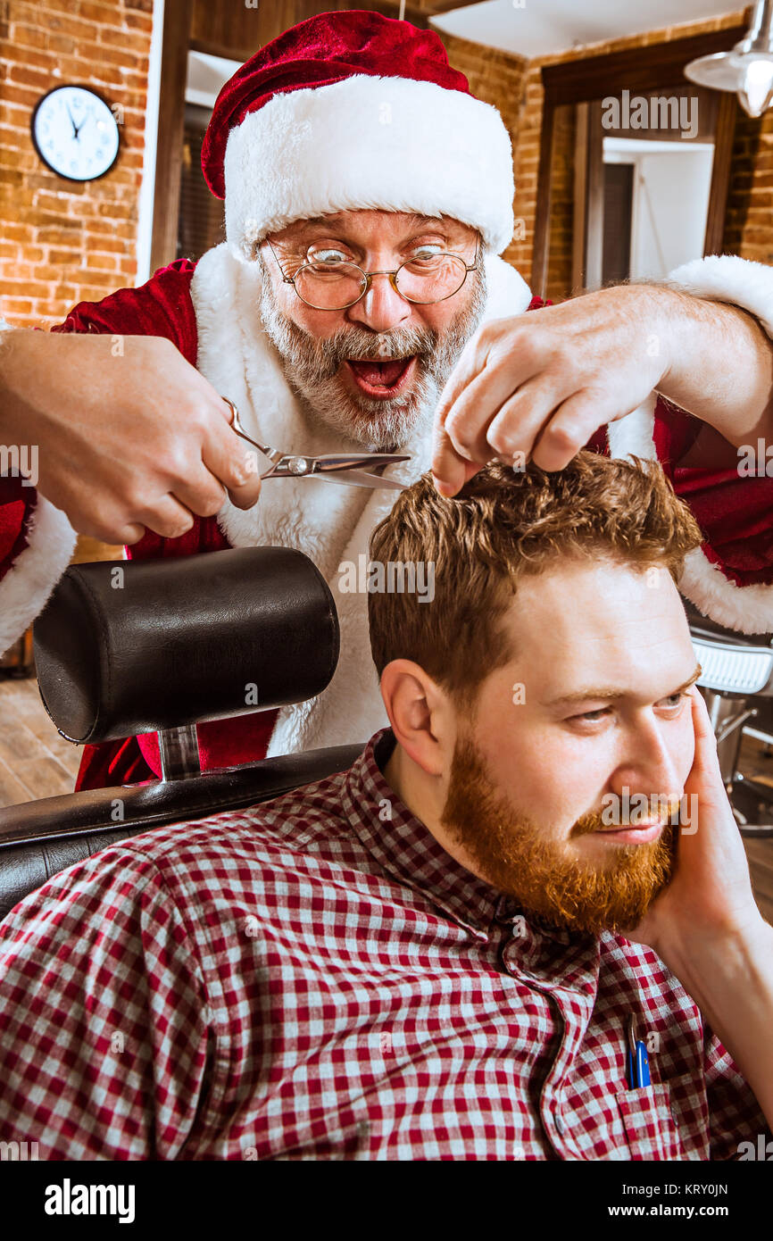 Santa claus as master at barber shop Stock Photo - Alamy