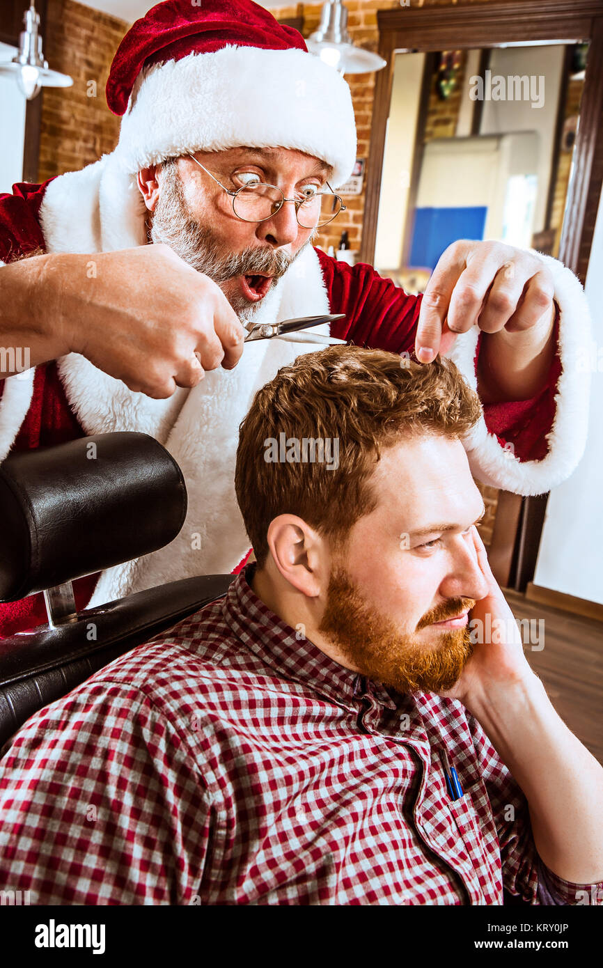 Santa claus as master at barber shop Stock Photo - Alamy