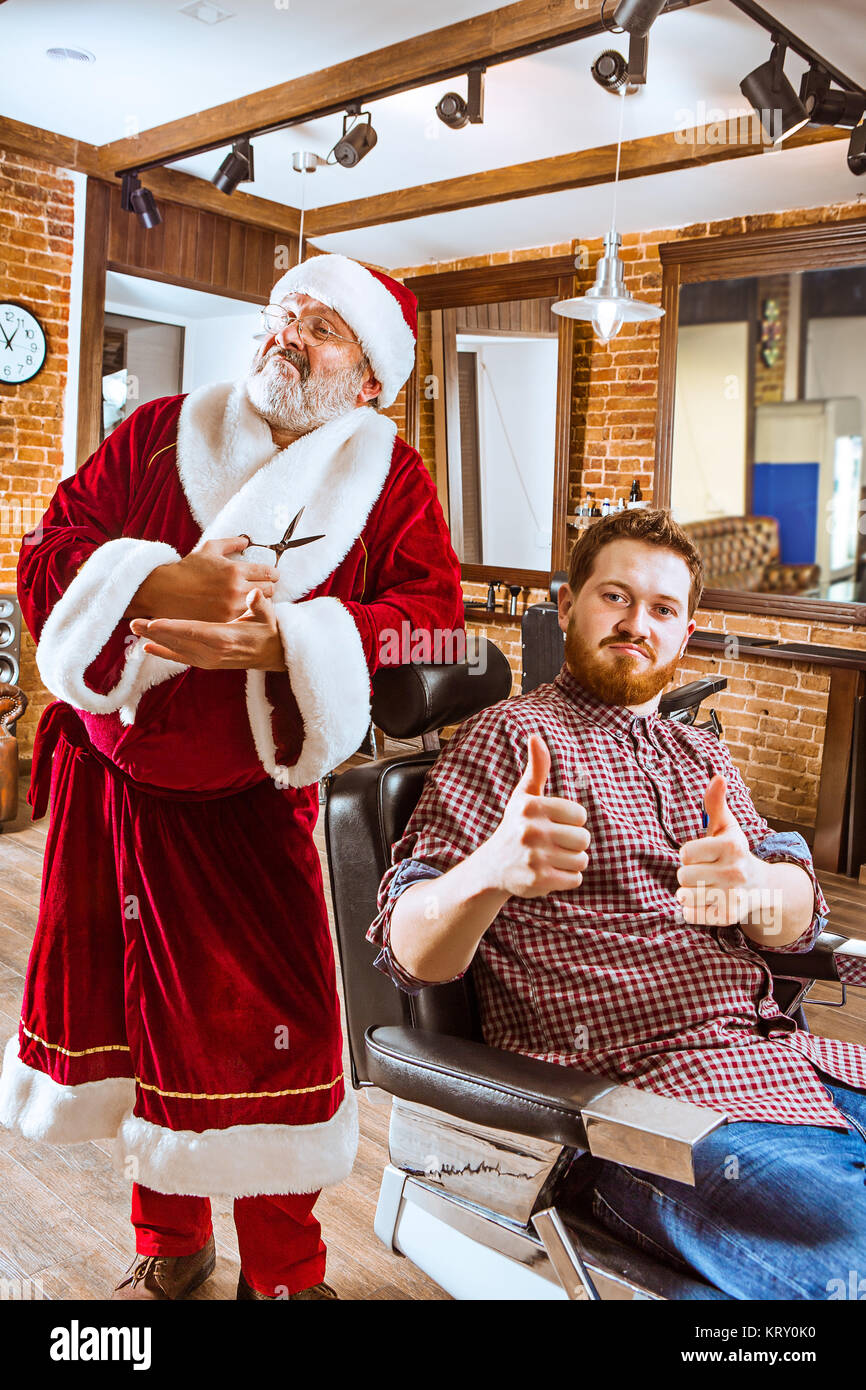 Santa claus as master at barber shop Stock Photo - Alamy