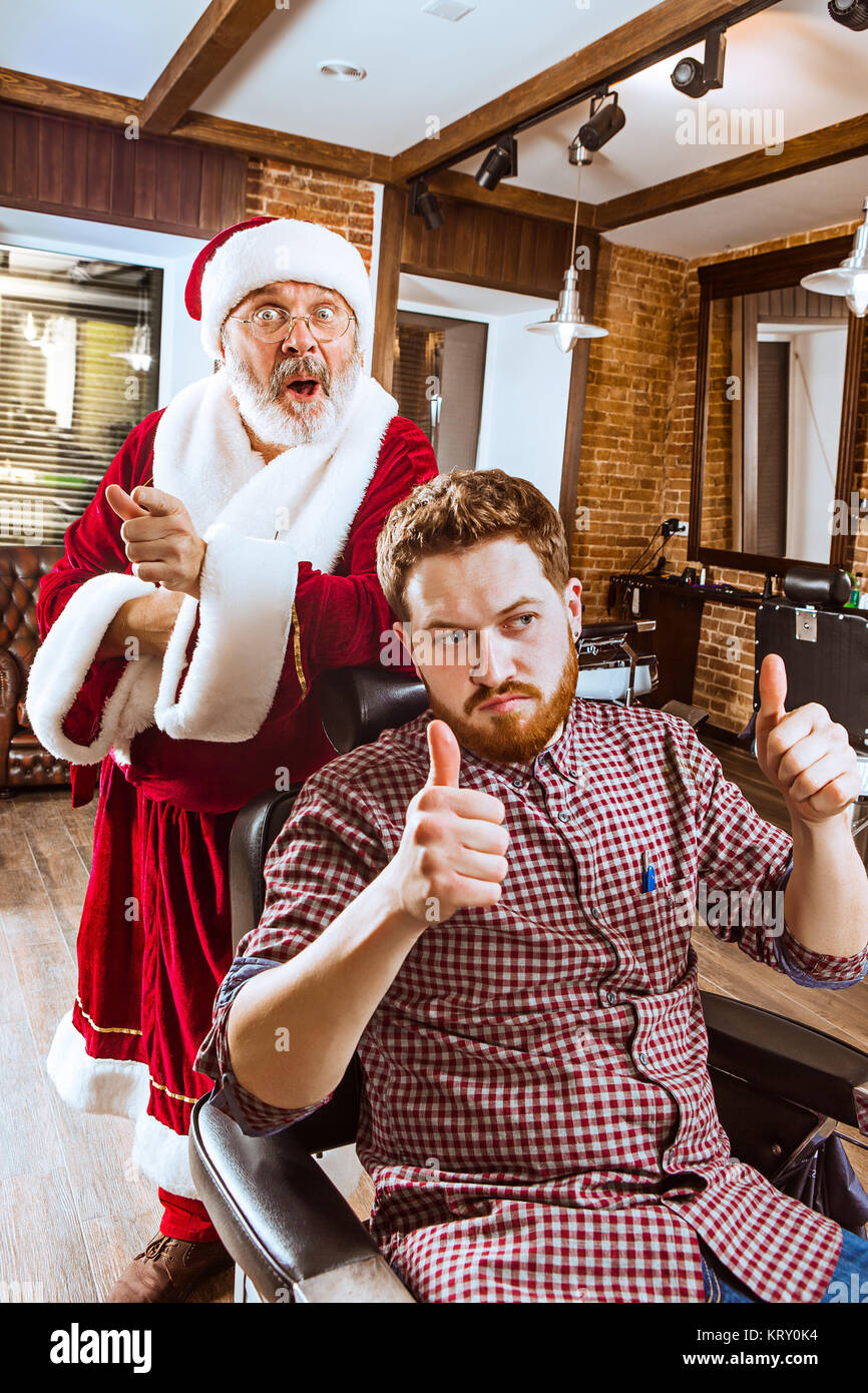 Santa claus as master at barber shop Stock Photo - Alamy