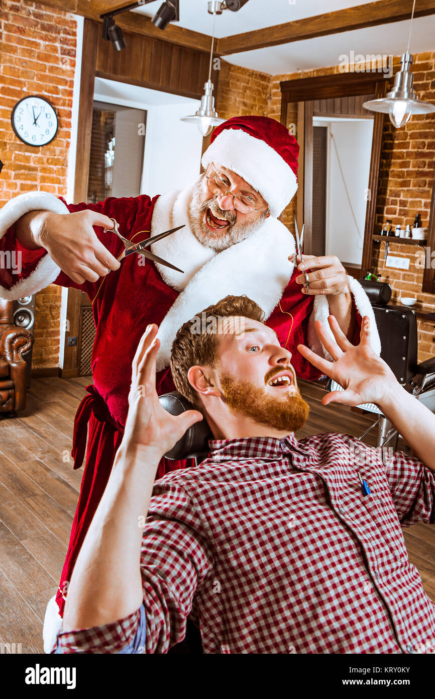 Santa claus as master at barber shop Stock Photo - Alamy