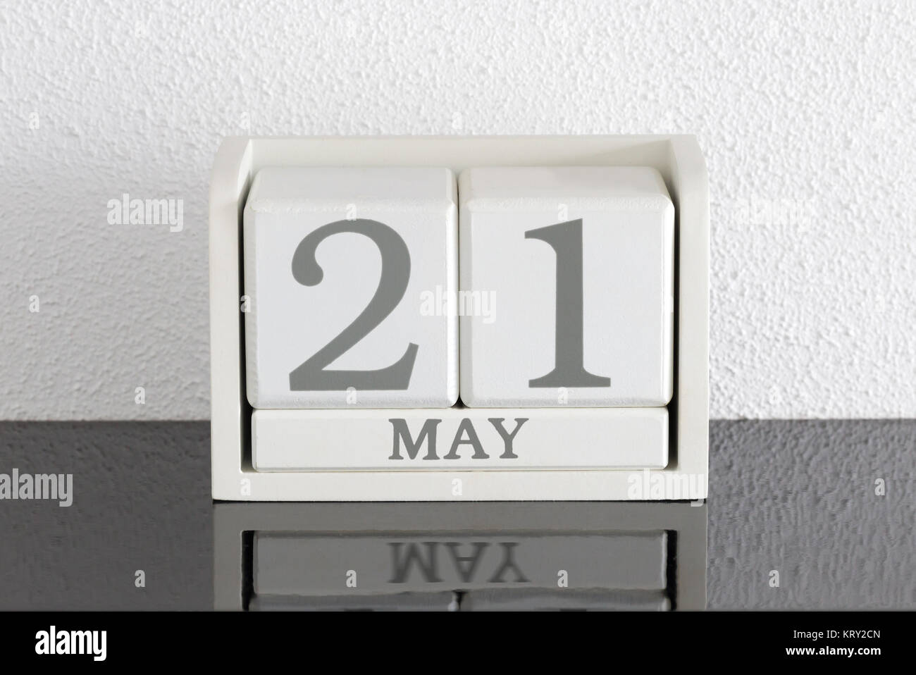 White block calendar present date 21 and month May on white wall ...