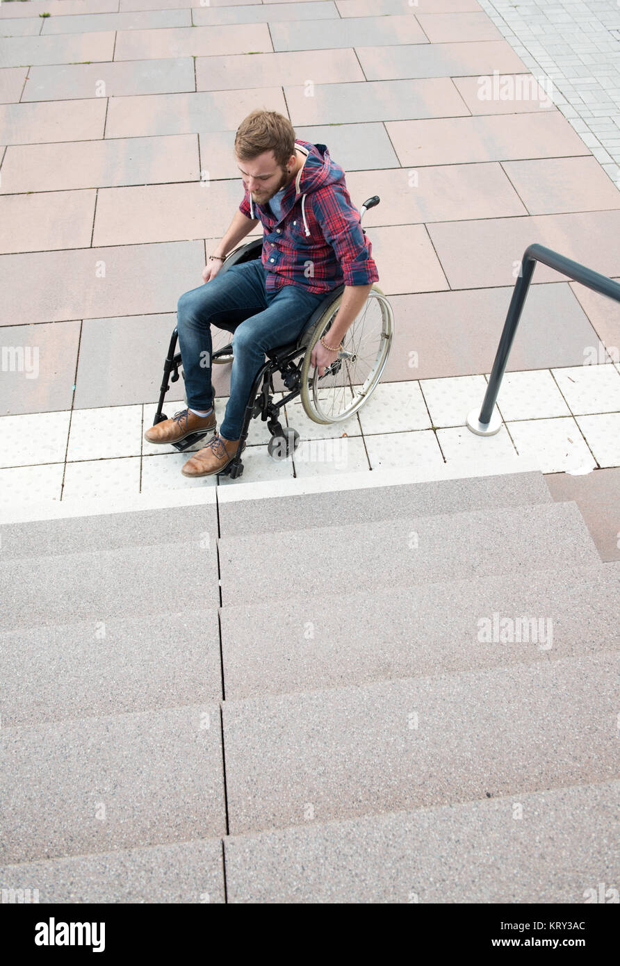 young disabled man in wheelchair in front of stairs from above Stock ...