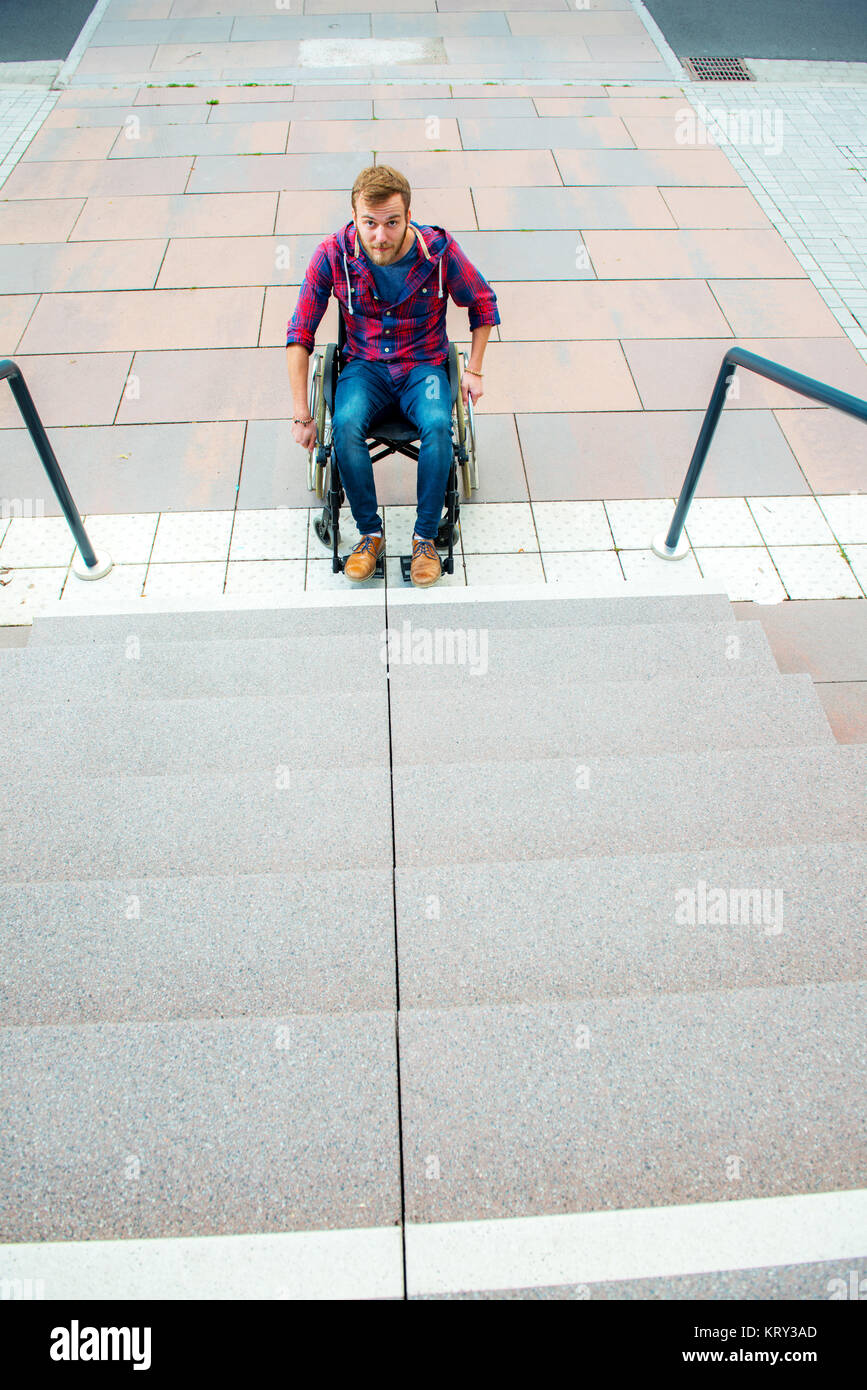 young disabled man in wheelchair in front of stairs from above Stock ...