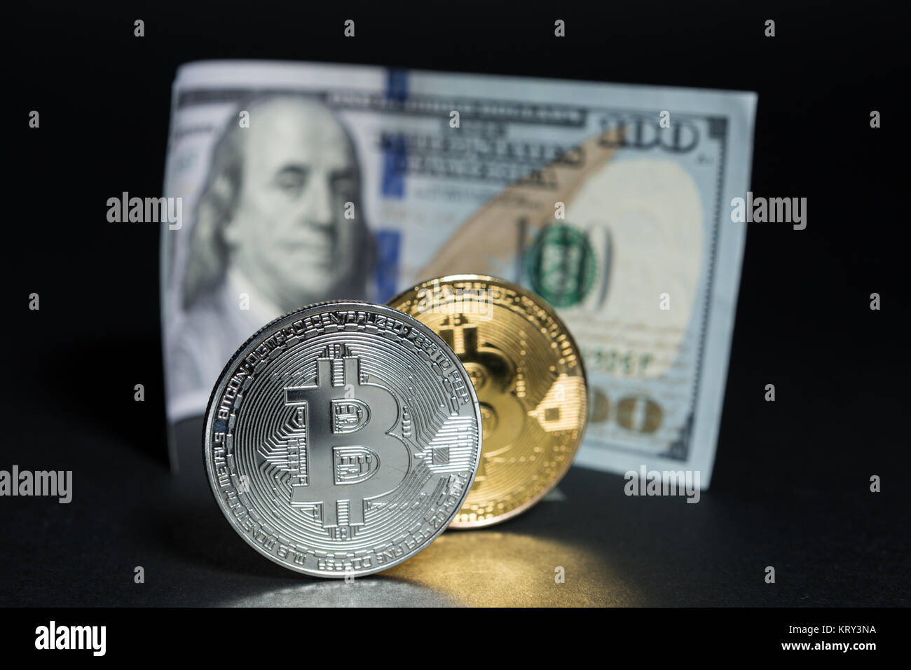 Bitcoins versus dollars concept with metal coins and paper banknote on ...