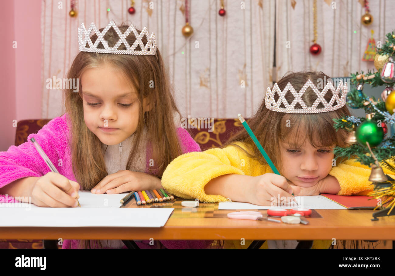 Sad Sisters write a letter to Santa Claus Stock Photo - Alamy
