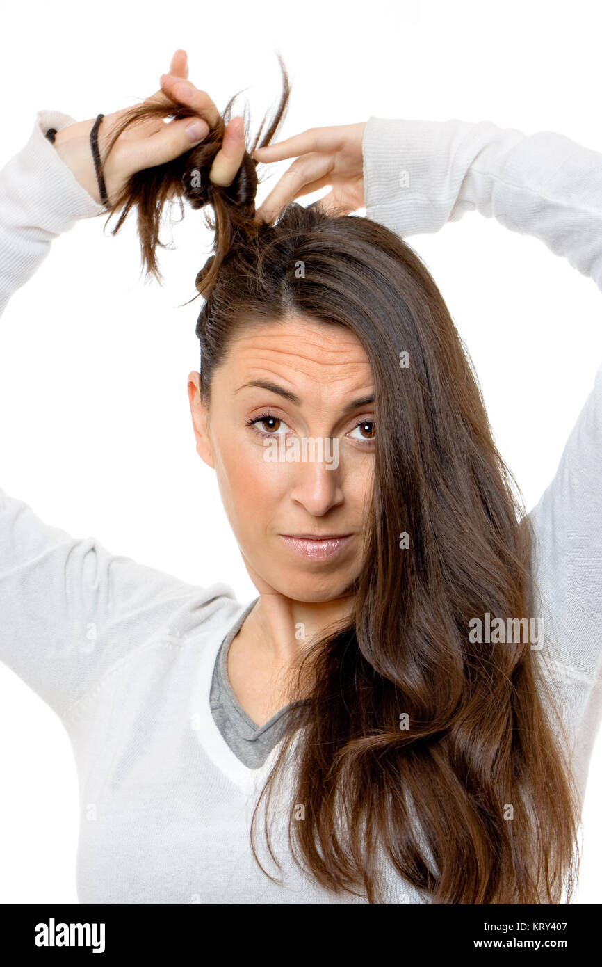 Beautiful young woman touching his hair Stock Photo - Alamy