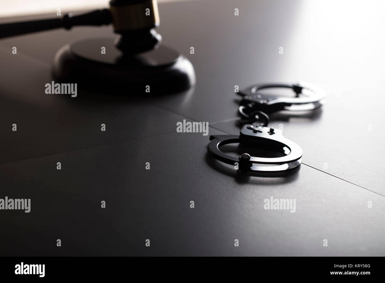 Criminal law concept. Cuffs and jugde gavel on stone background Stock ...