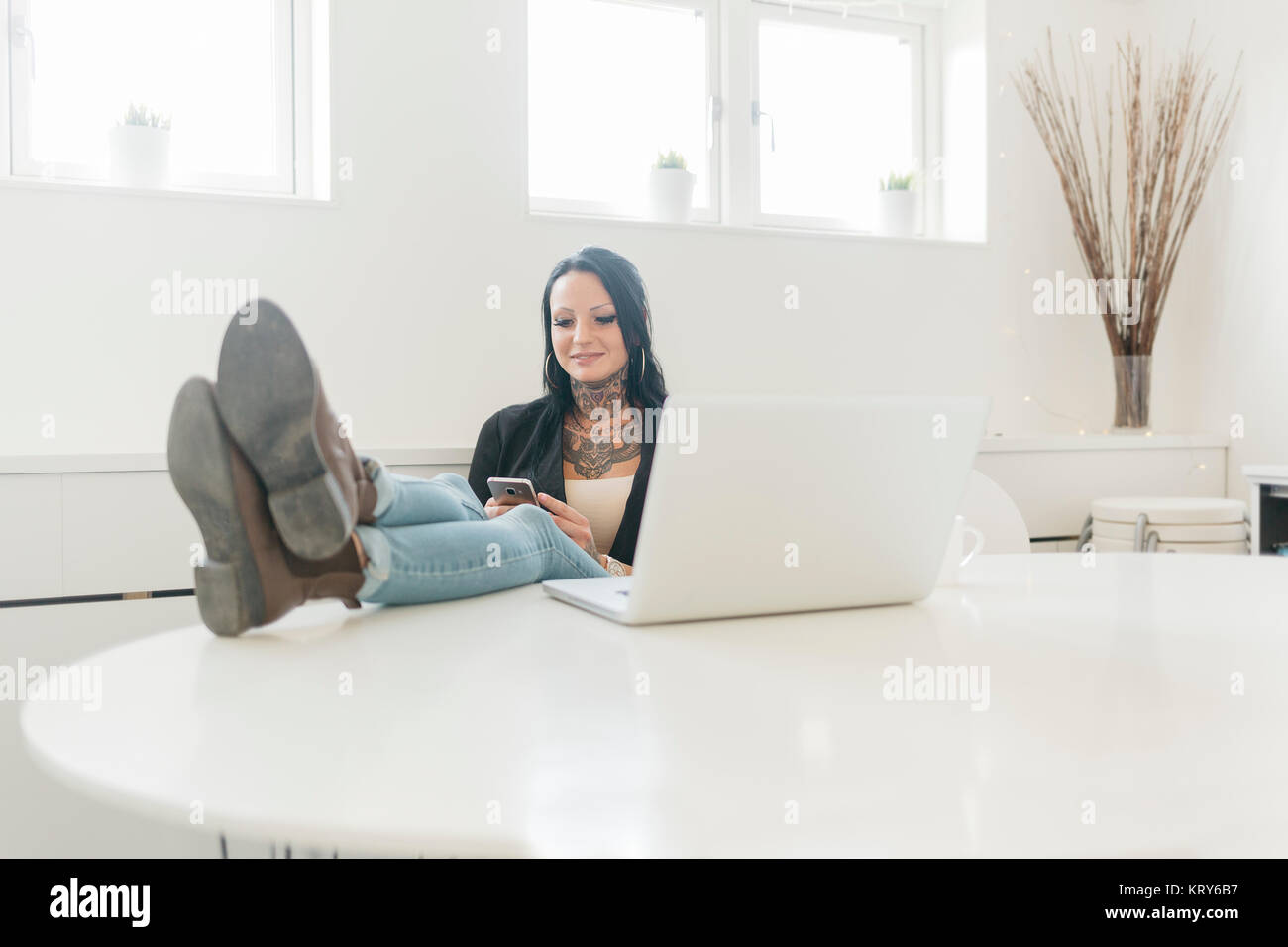 Woman sitting table feet up hi-res stock photography and images - Alamy