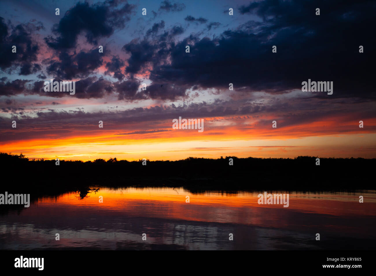 Sunset over water Stock Photo - Alamy