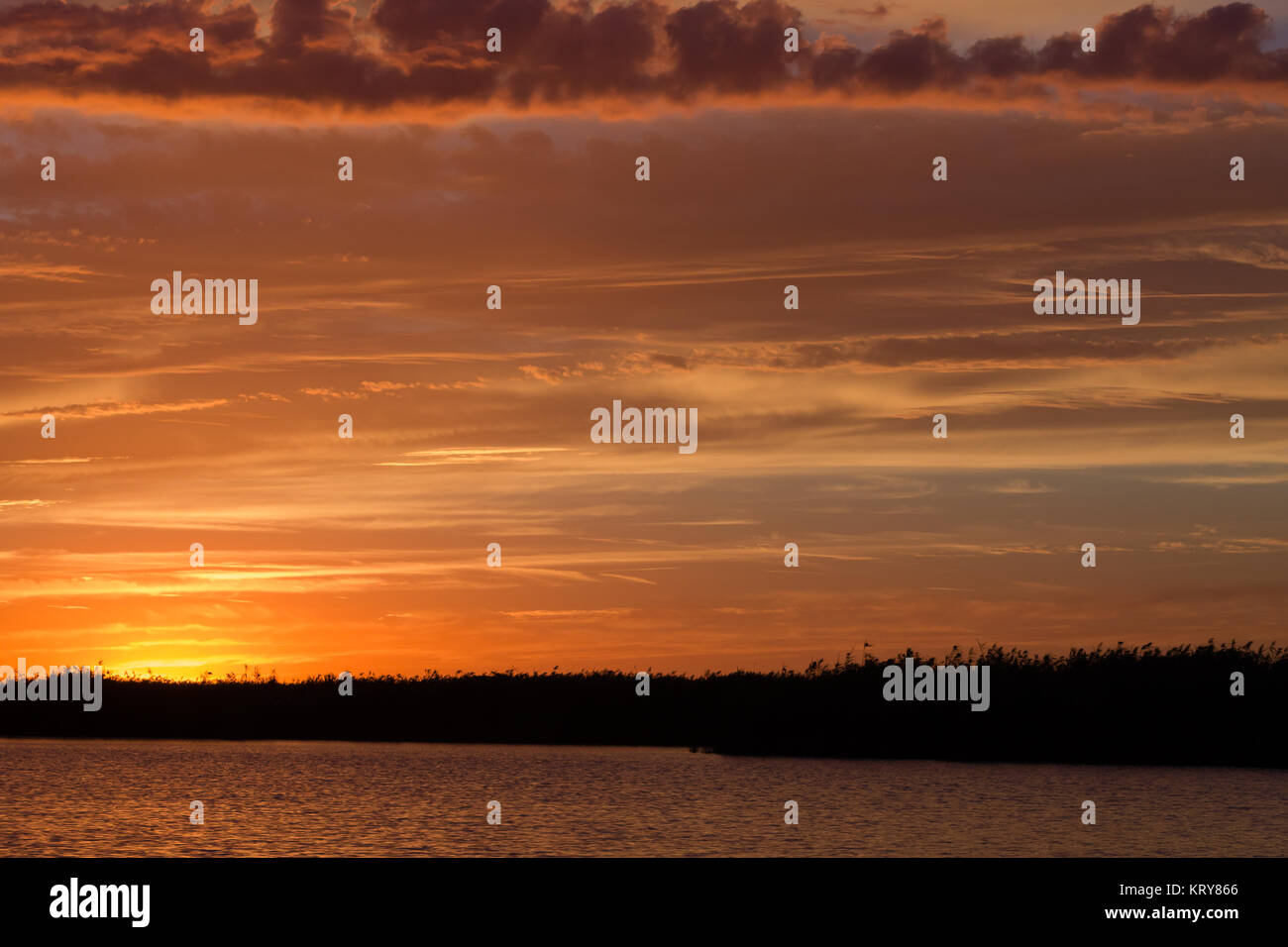 Sunset over water Stock Photo - Alamy