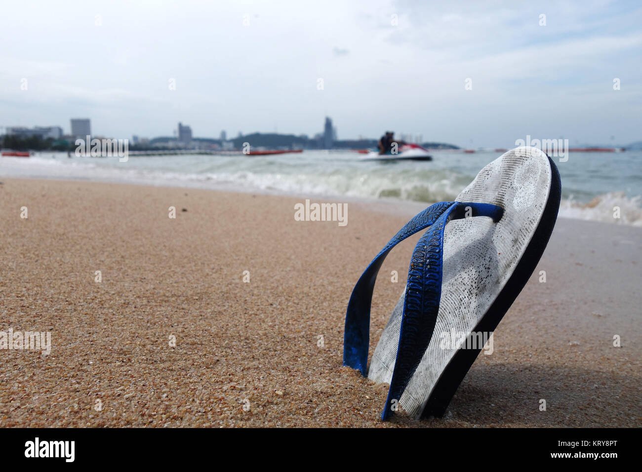 Beach slippers on a sandy beach Stock Photo - Alamy