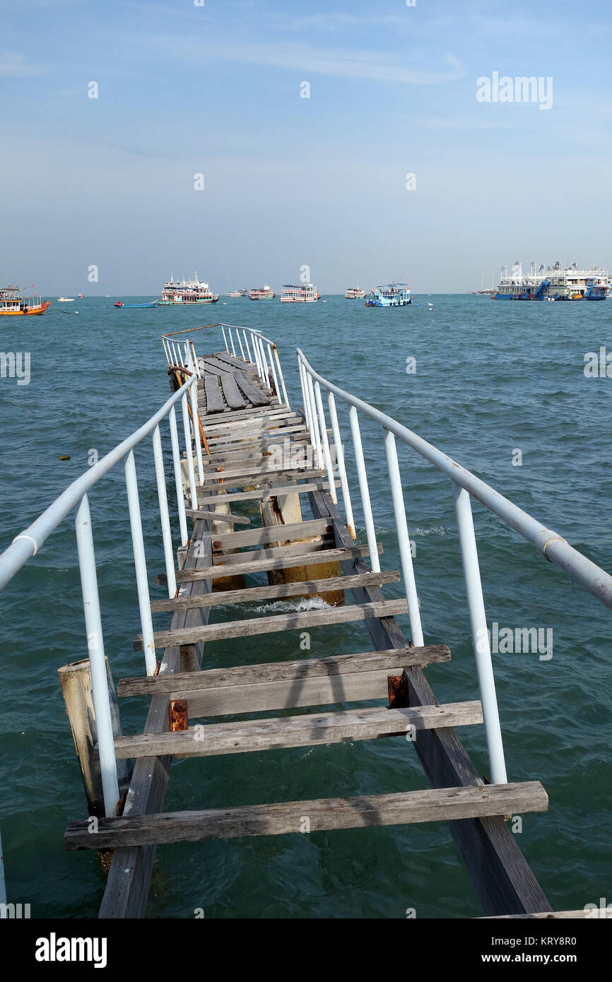 The wooden bridge extending into the sea Stock Photo - Alamy