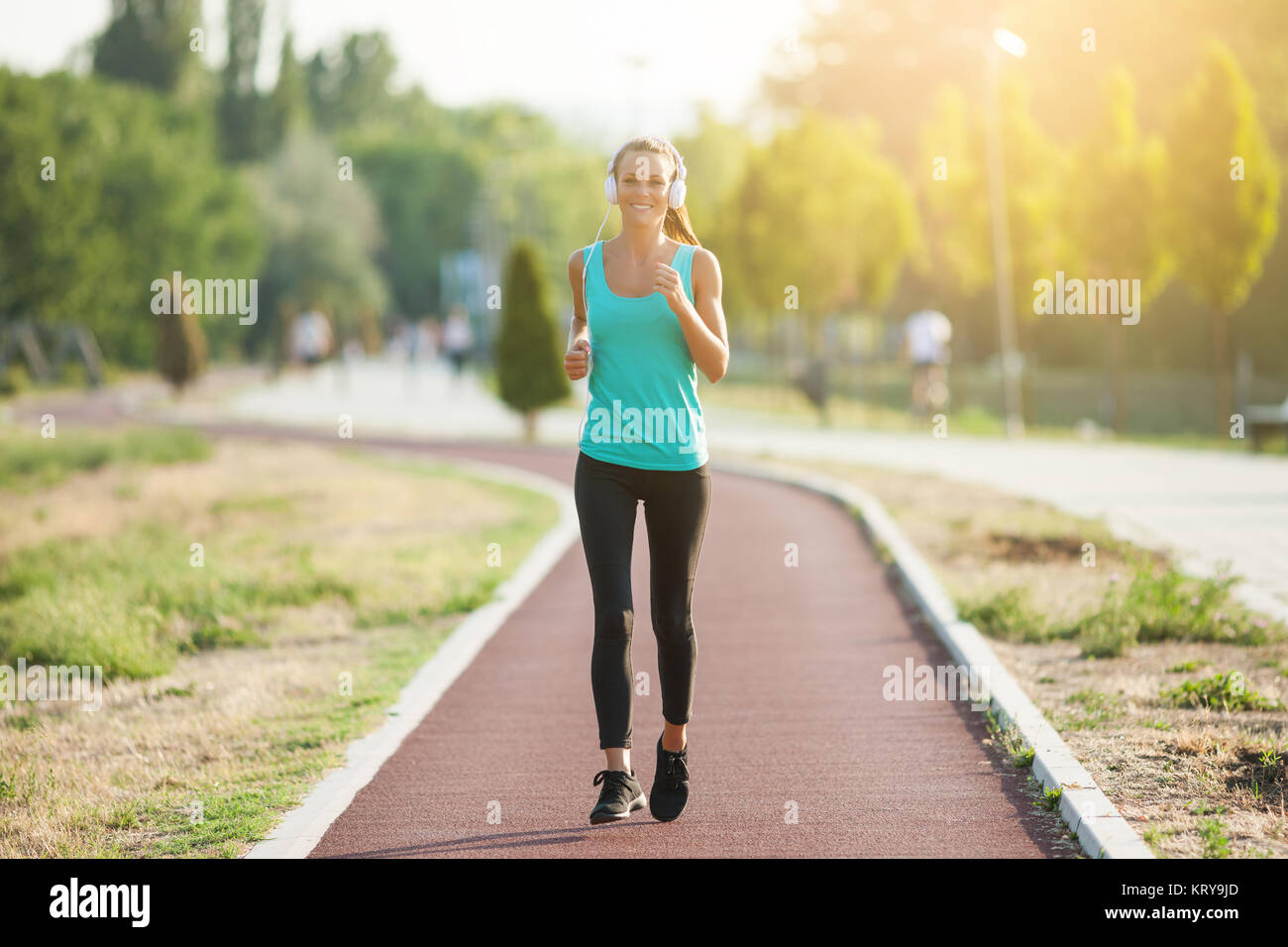 Young woman is jogging on sunny day Stock Photo - Alamy