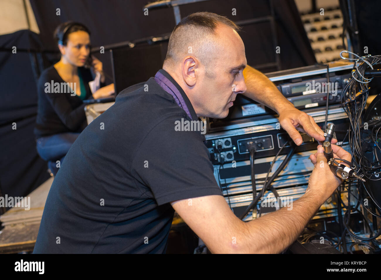 Sound man setting up equipment Stock Photo - Alamy