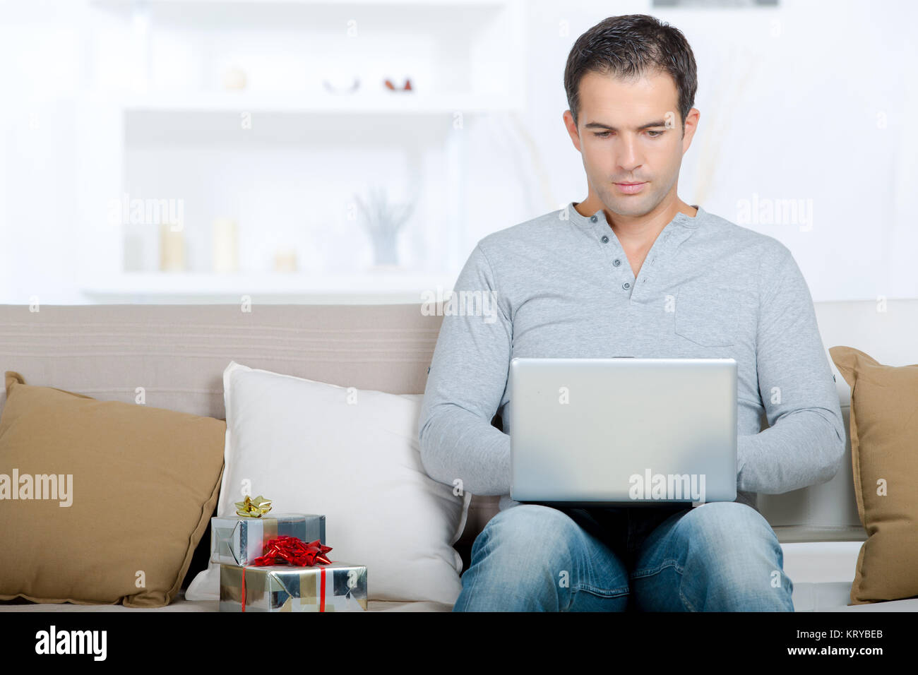 happy man sitting with laptop computer on sofa Stock Photo - Alamy