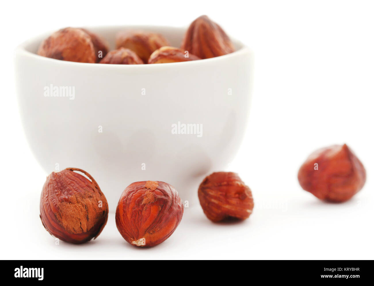 Hazelnut in a bowl over white background Stock Photo - Alamy