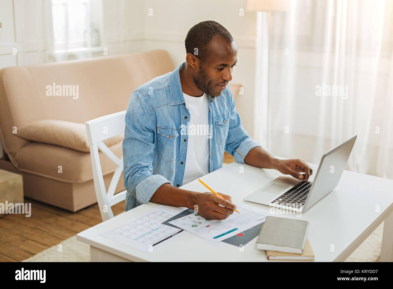 Cheerful self-employed man working from home Stock Photo - Alamy