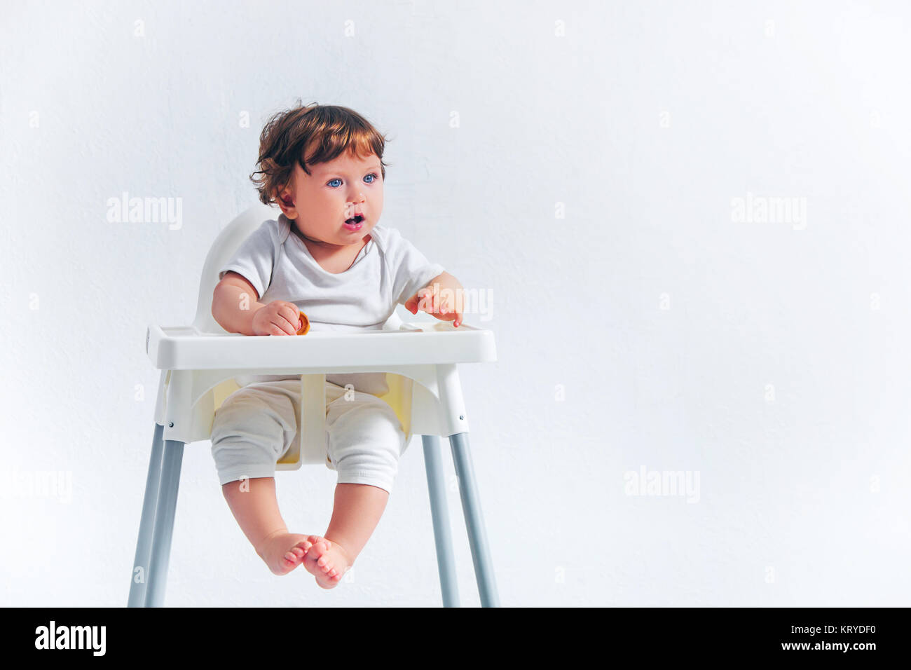 Happy baby boy sitting on studio background Stock Photo - Alamy