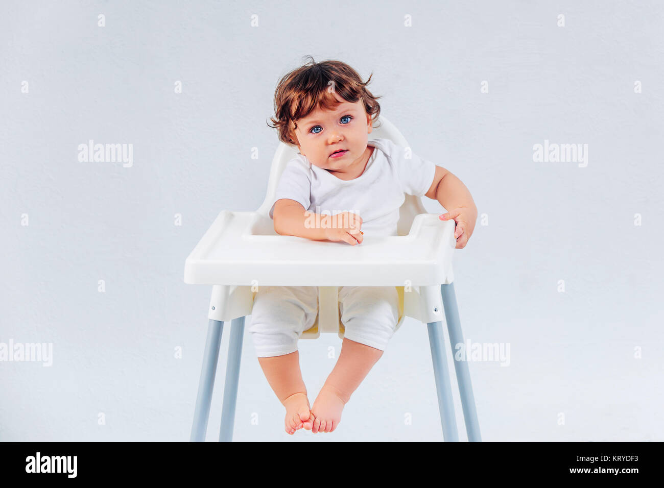 Happy baby boy sitting on studio background Stock Photo - Alamy