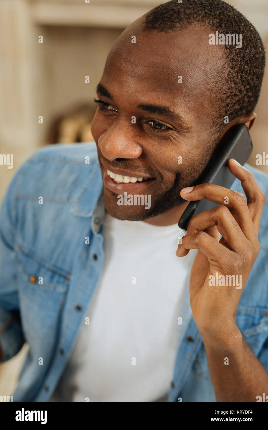 Exuberant smiling man talking on the phone Stock Photo - Alamy