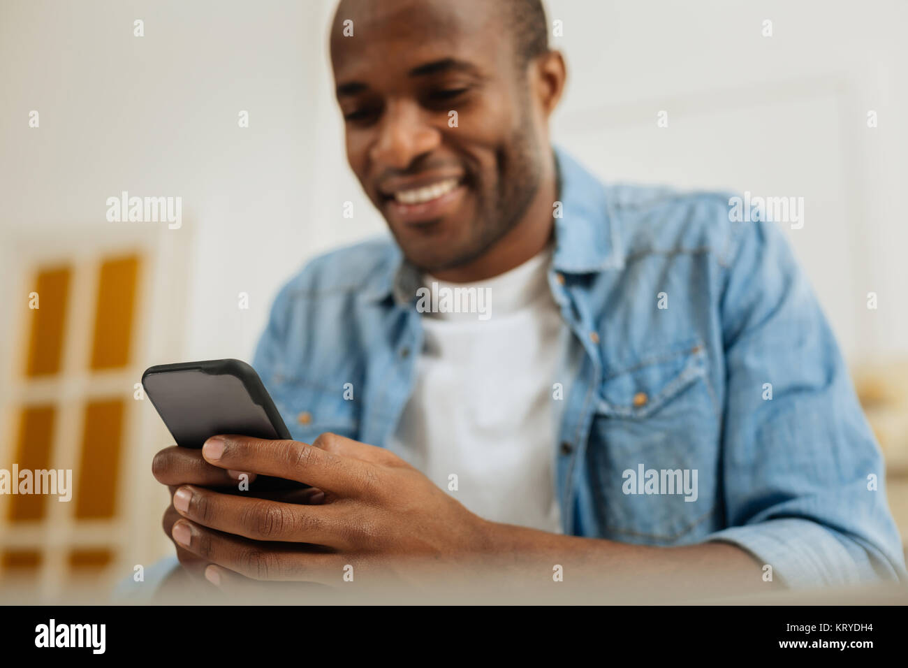 Inspired young man sending messages Stock Photo - Alamy