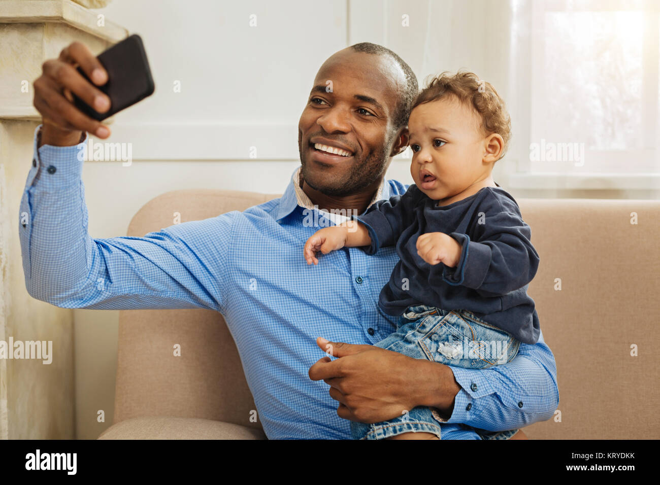 Exuberant man taking selfies with his kid Stock Photo - Alamy