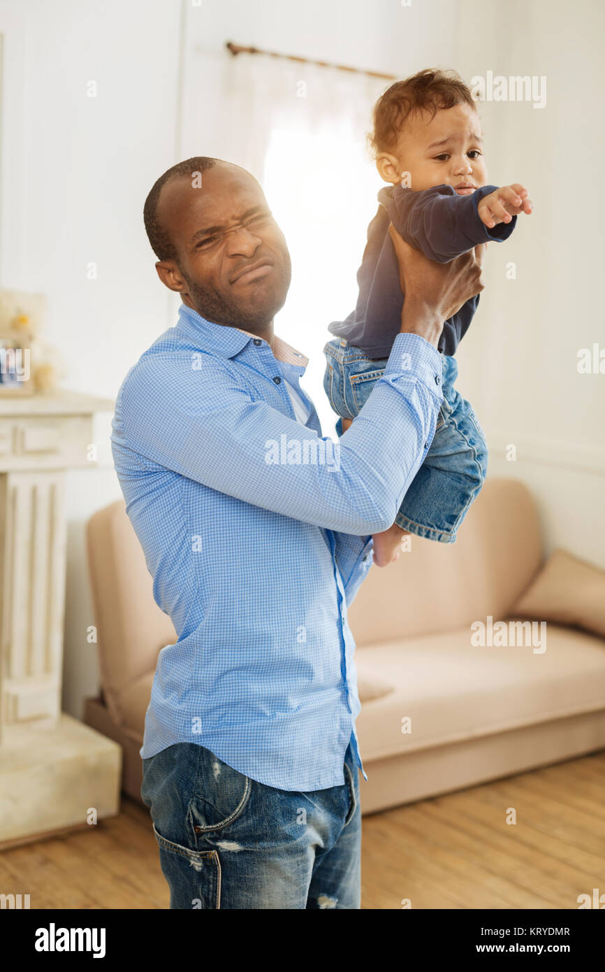 Sad father holding his little boy Stock Photo - Alamy