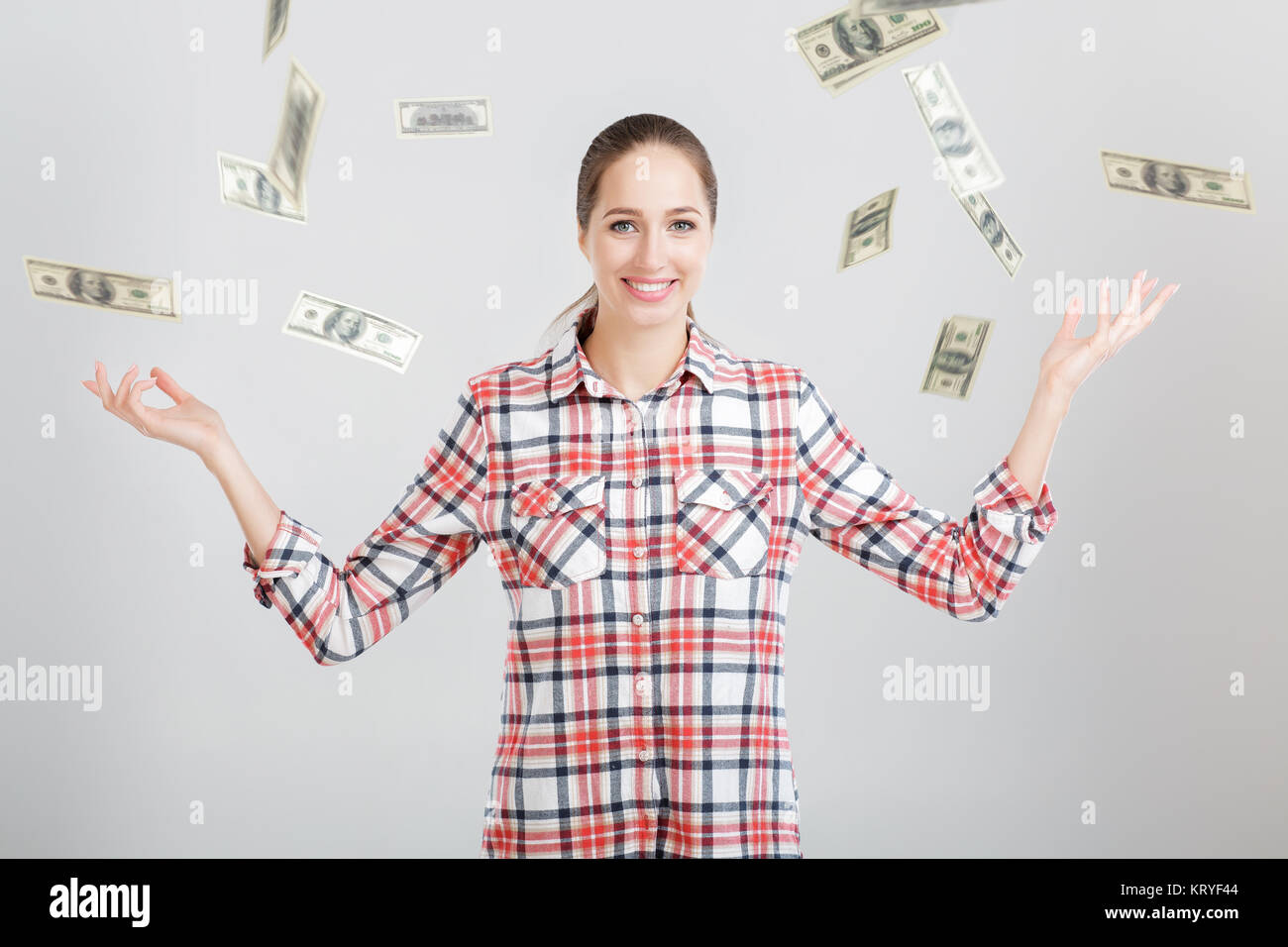 happy woman standing under money rain Stock Photo - Alamy