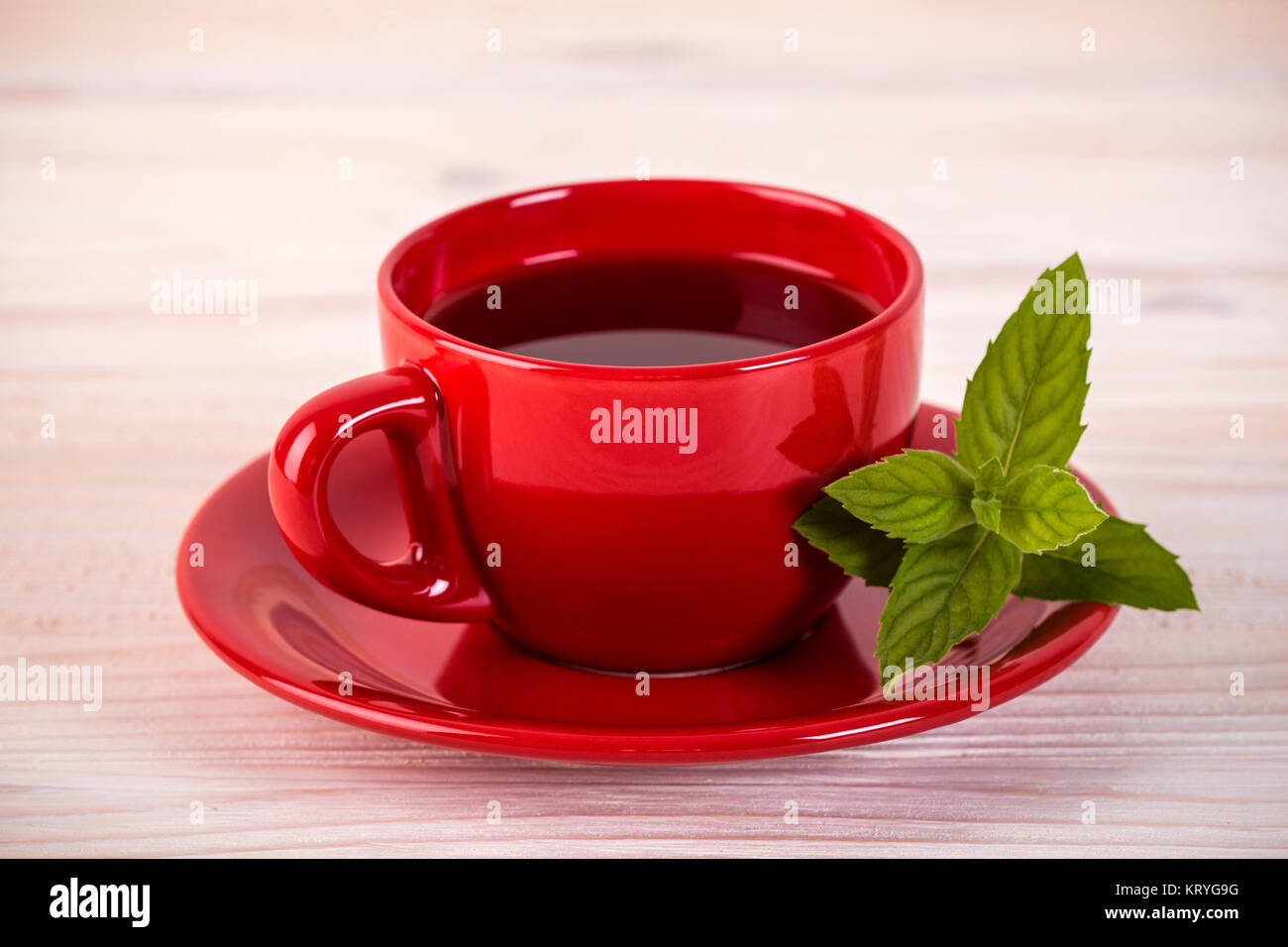 Red cup of tea with green leaves Stock Photo - Alamy