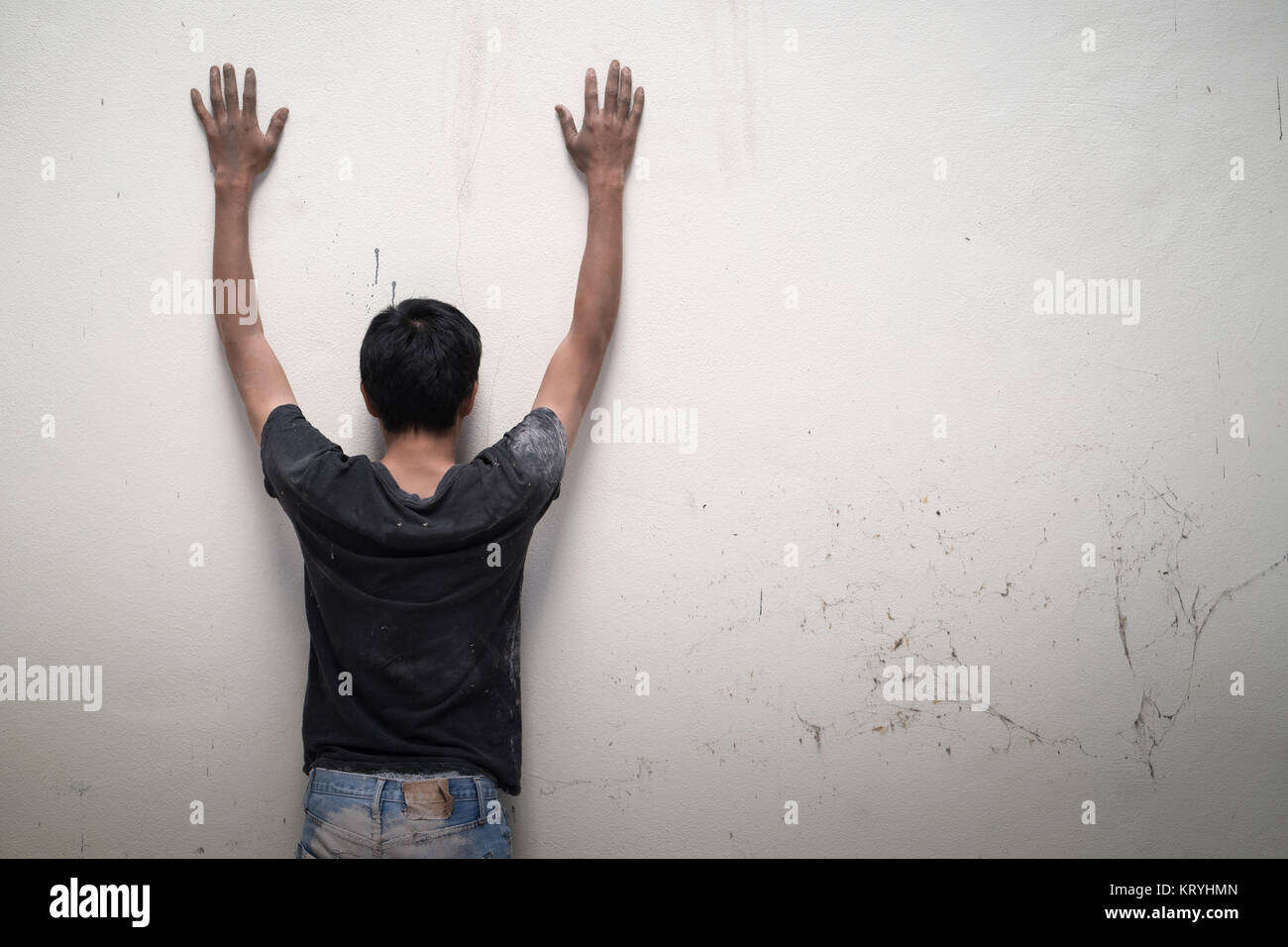 man show hands up facing the wall Stock Photo - Alamy