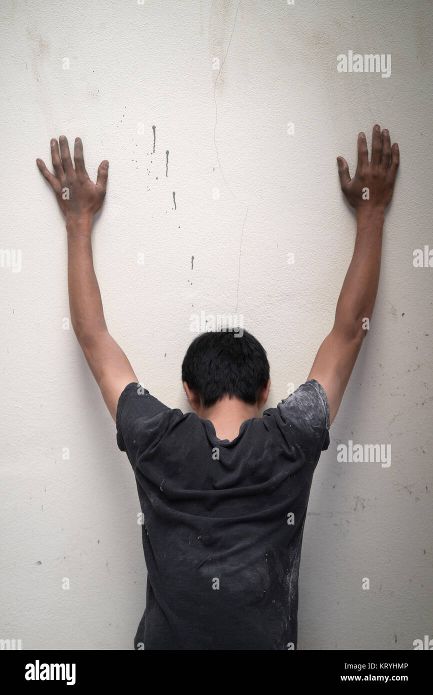 man show hands up facing the wall Stock Photo - Alamy