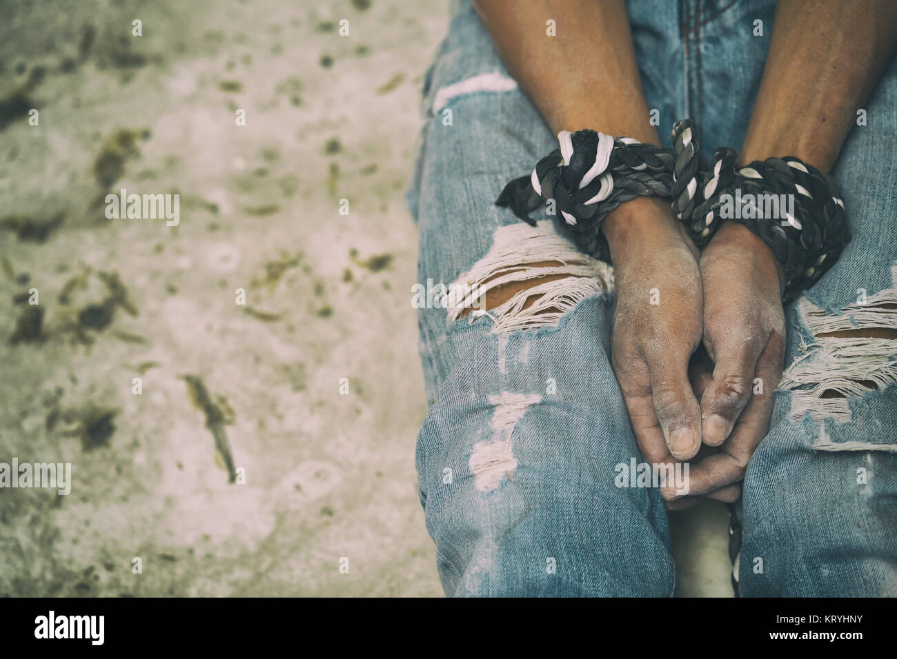 hopeless man hands tied together with rope Stock Photo - Alamy