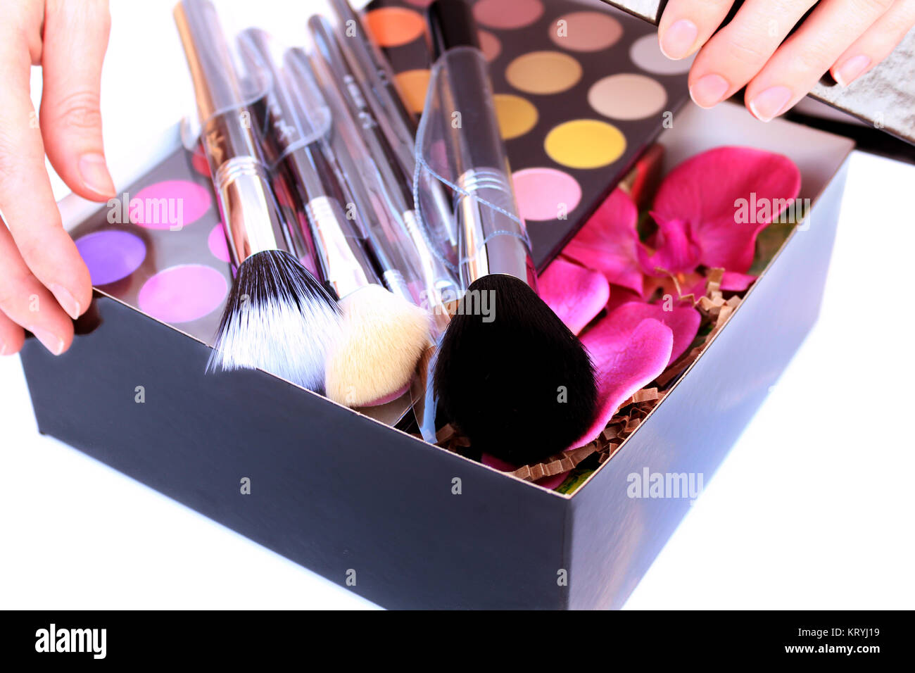 A Woman opening a gift box containing cosmetics brushes and makeup ...
