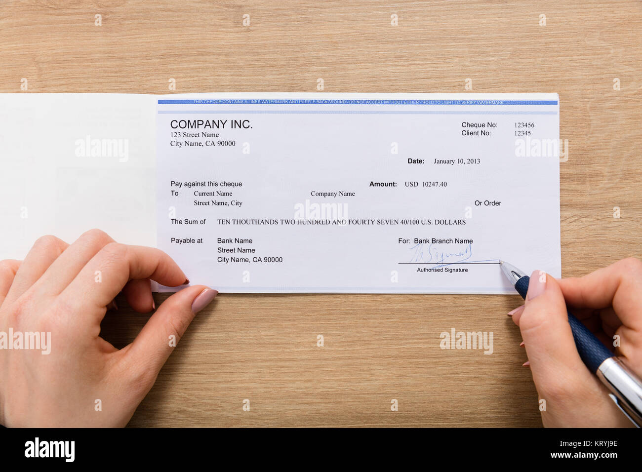 Person Hand Signing Cheque Stock Photo - Alamy