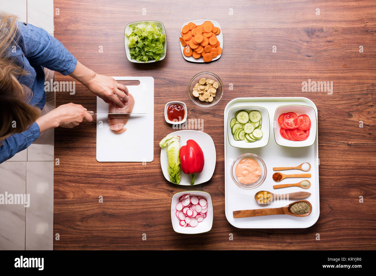 Woman Cutting Meat On Chopping Board Stock Photo - Alamy