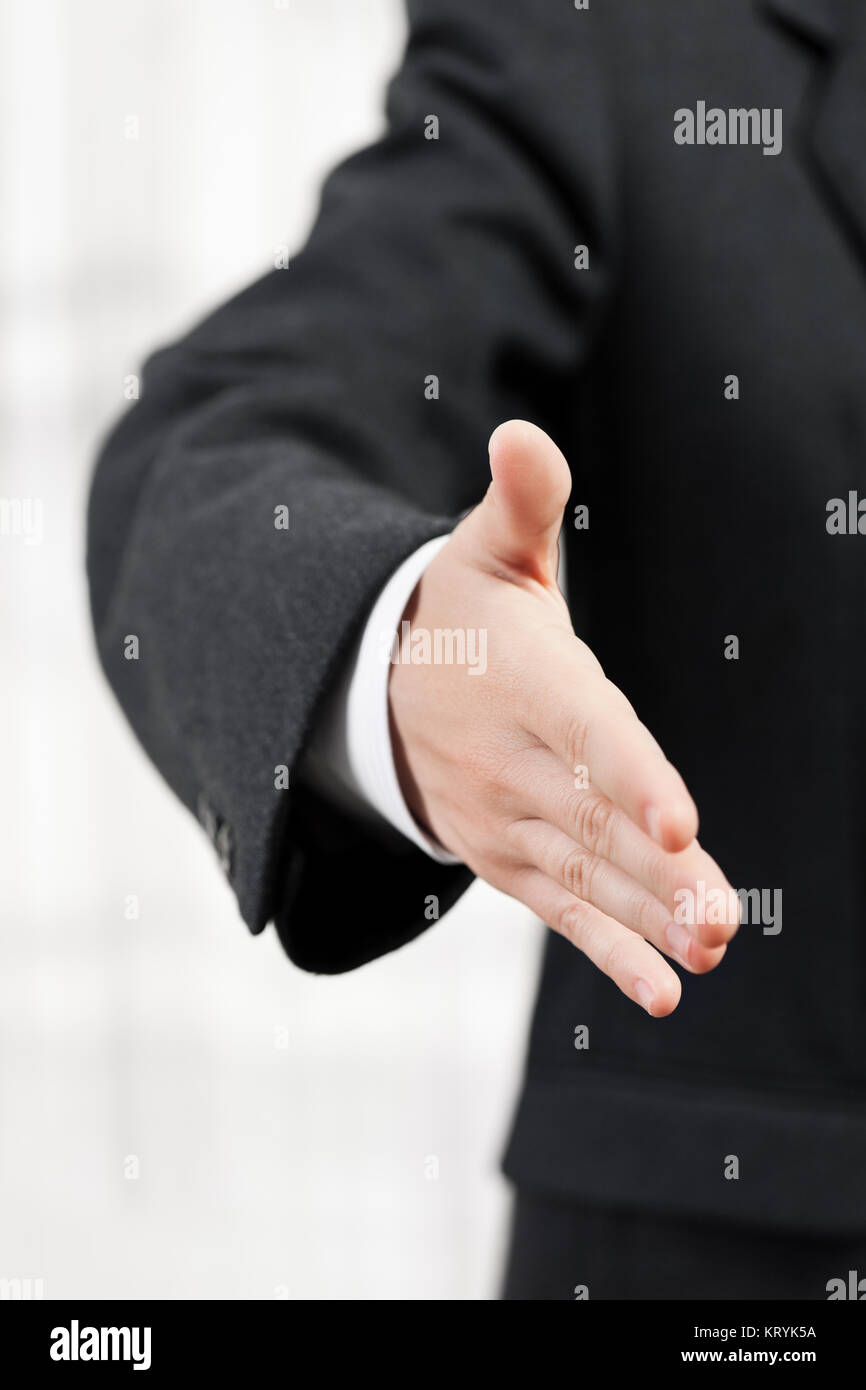 Businessman in black suit gesturing hand greeting or meeting handshake ...