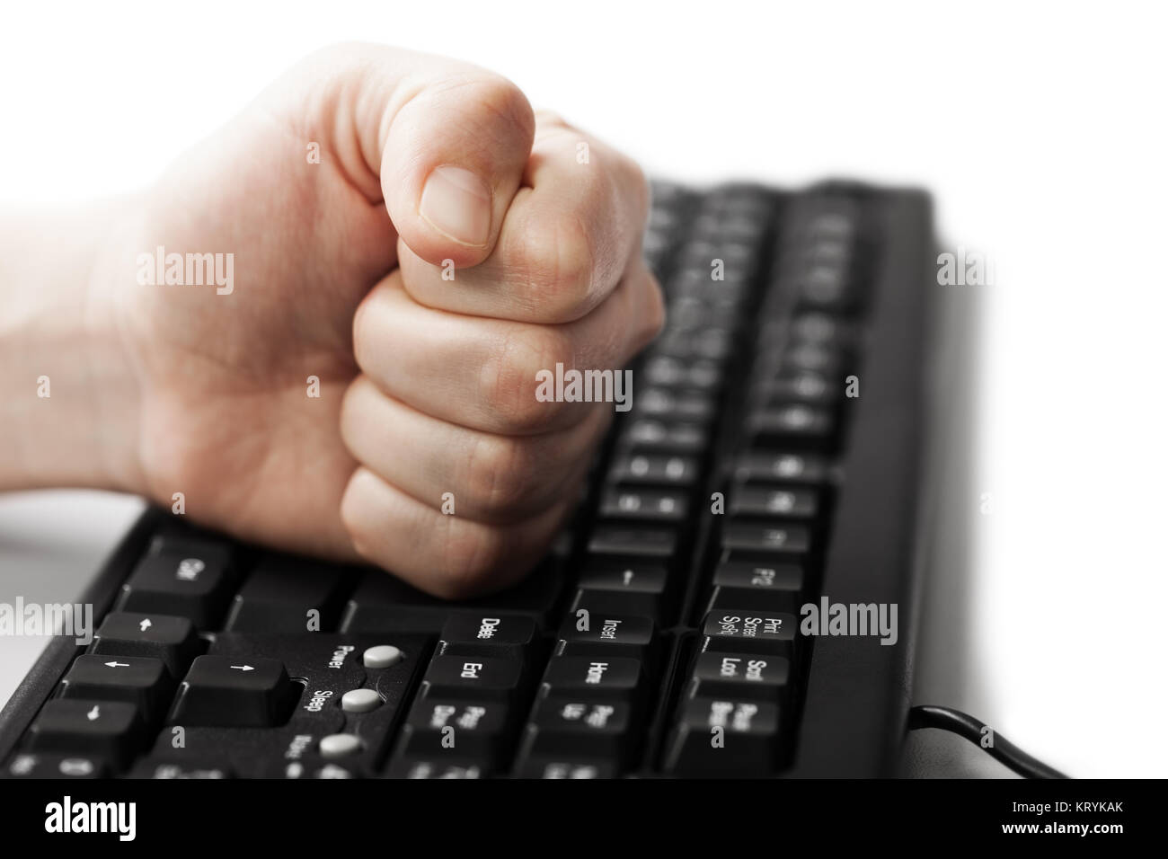 Angry business man hand fist on pc computer keyboard Stock Photo - Alamy