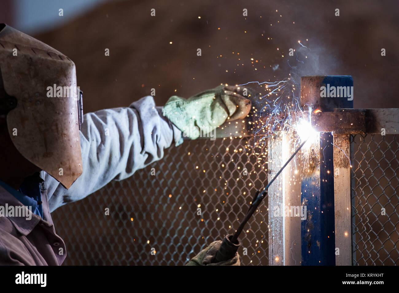Heavy industry welder worker in protective mask hand holding arc ...