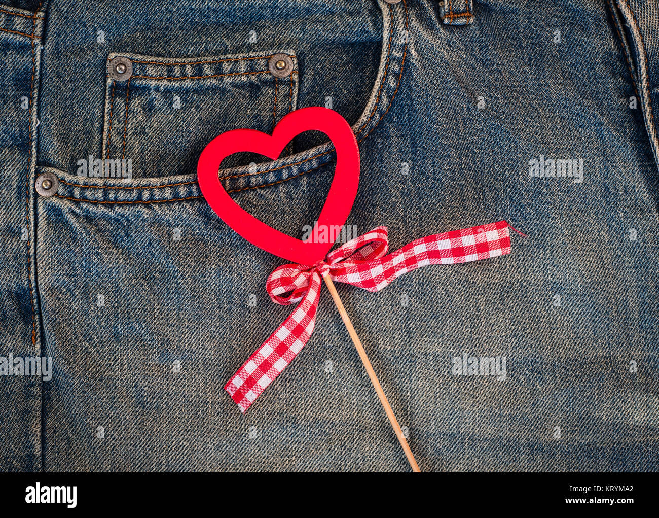 Red wooden heart on a background of blue worn jeans Stock Photo - Alamy