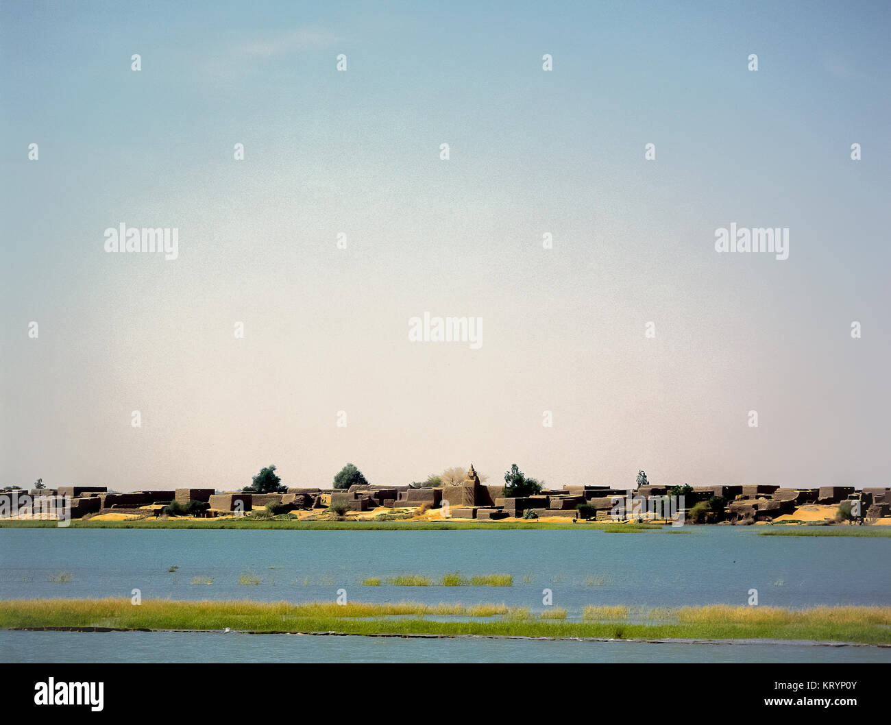 View of a village by the Niger river and adobe buildings, Mali Stock ...