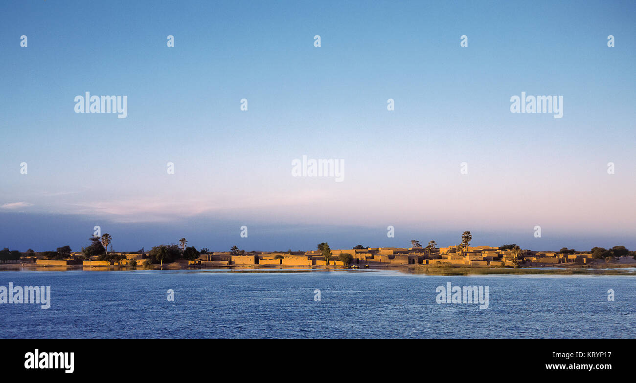 View of a village by the Niger river and adobe buildings, Mali Stock ...